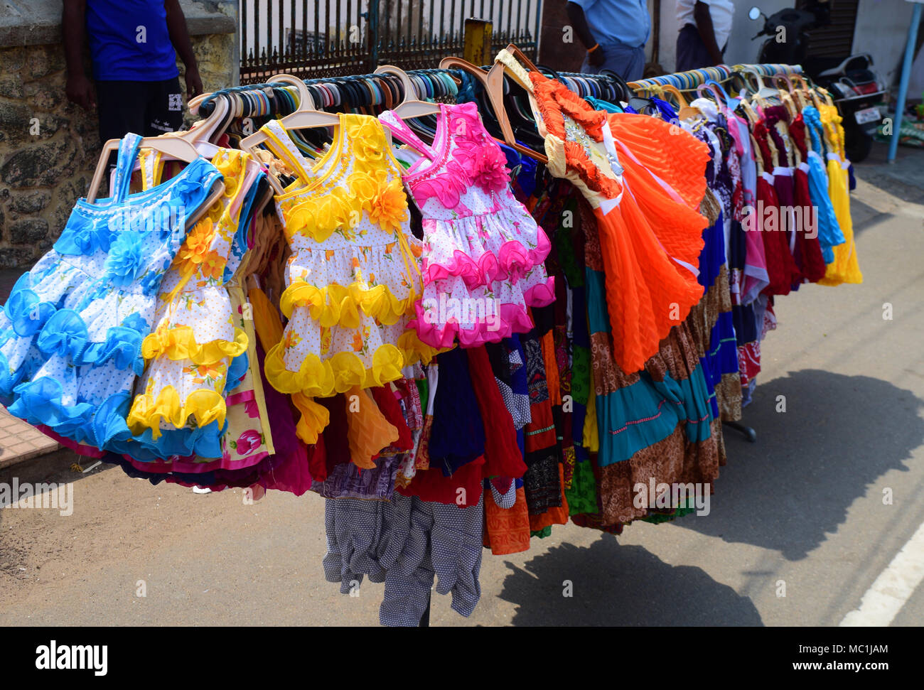 Selling cute, colorful and beautiful dresses of kids in a street in ...