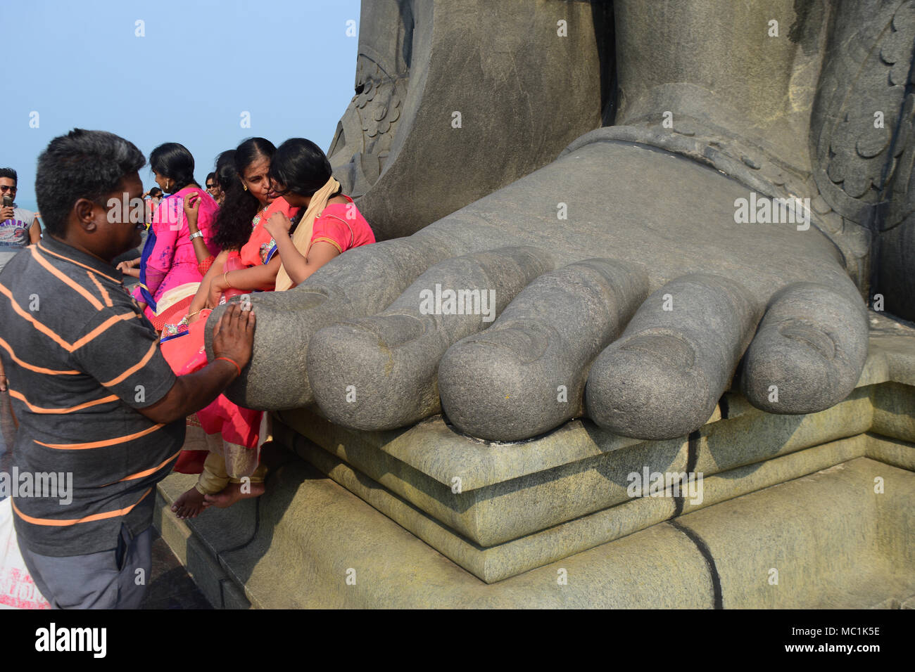A man touches the feet of a big statue of Thiruvalluvar in kanyakumari , Tamil Nadu ,India Stock ...
