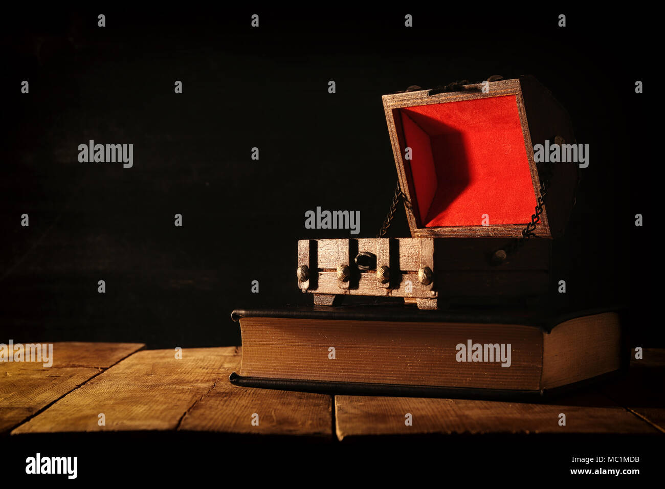 Image of empty mysterious treasure chest over old book on wooden table ...