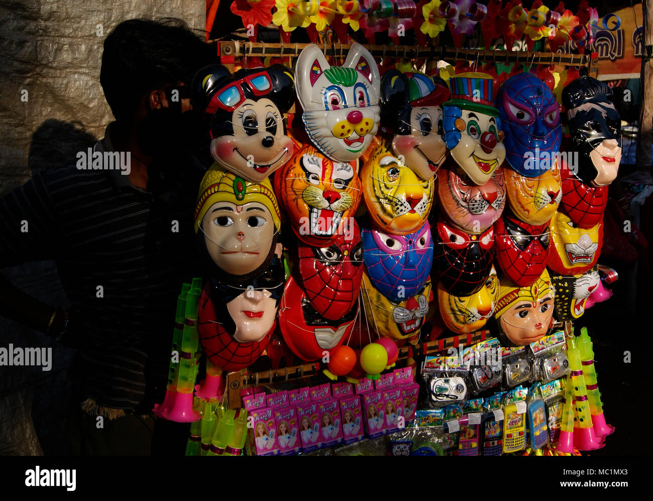 A man selling cartoon character kids face masks and other toys in the ...