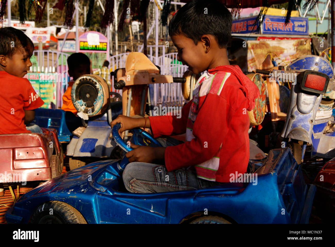 Image of Small kids are enjoying car ride in a festival stall in kerala ...
