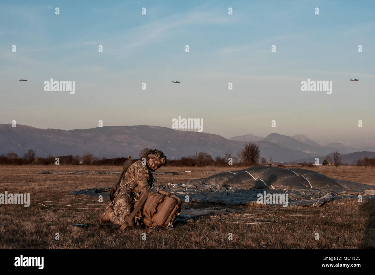 Three US Air Force C-130 Hercules fly in by the Dolomite Mountains in ...