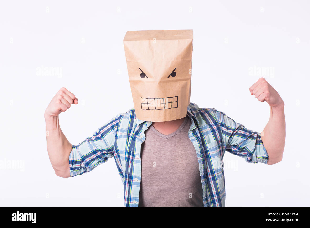 Man with cardboard box on his head and drawing of angry emoticon face ...