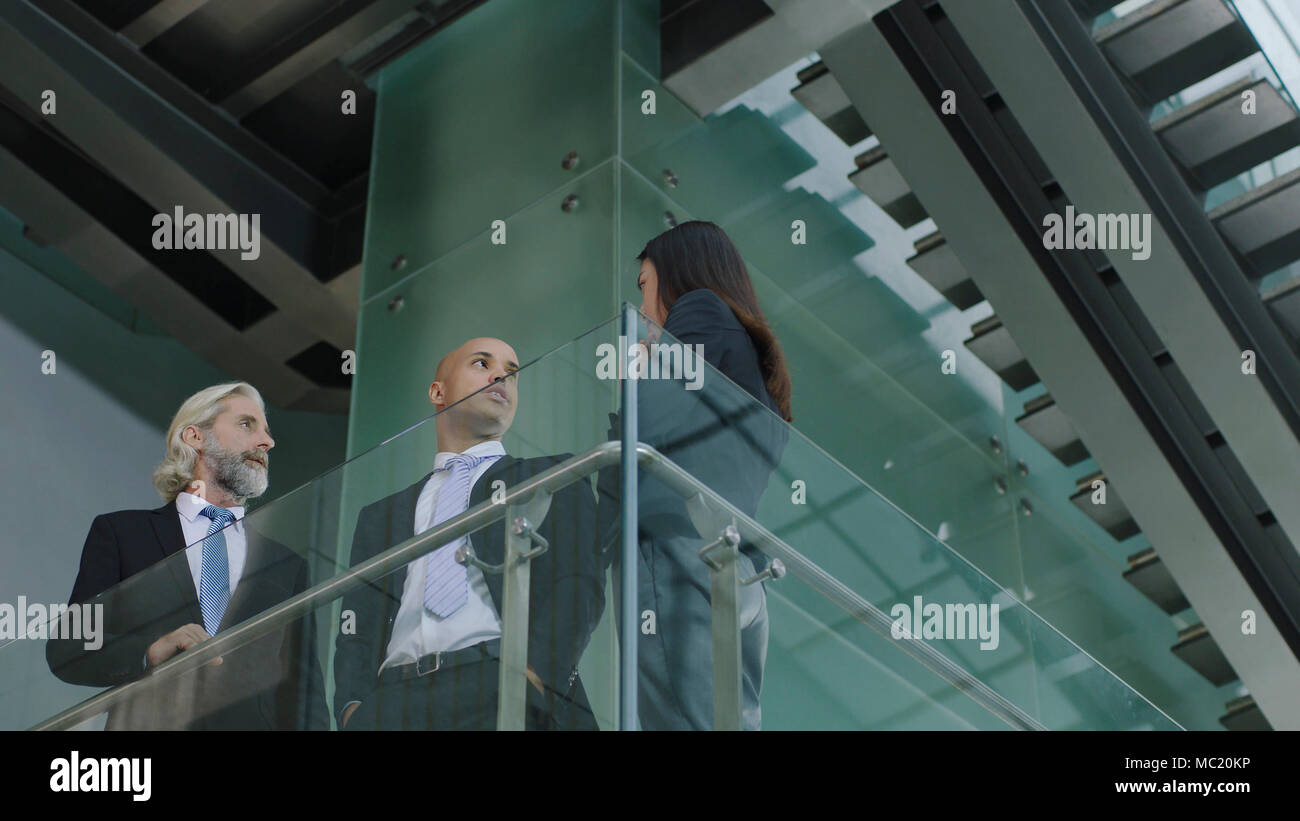 three multinational company executives standing on second floor of ...
