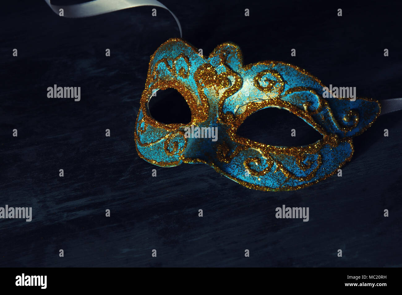 Image of elegant blue and gold venetian, mardi gras mask over black ...