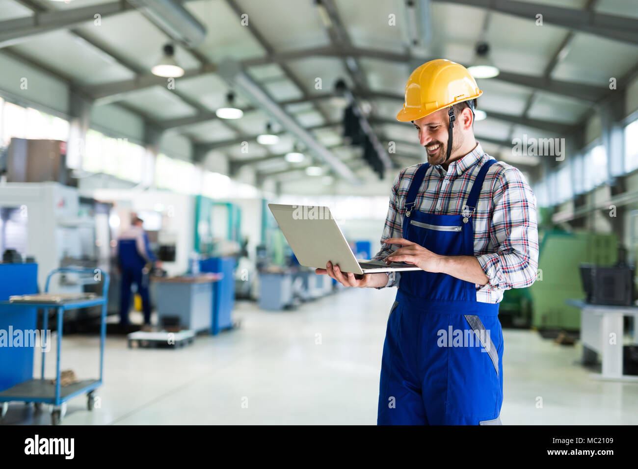 modern industrial machine operator working in factory Stock Photo - Alamy