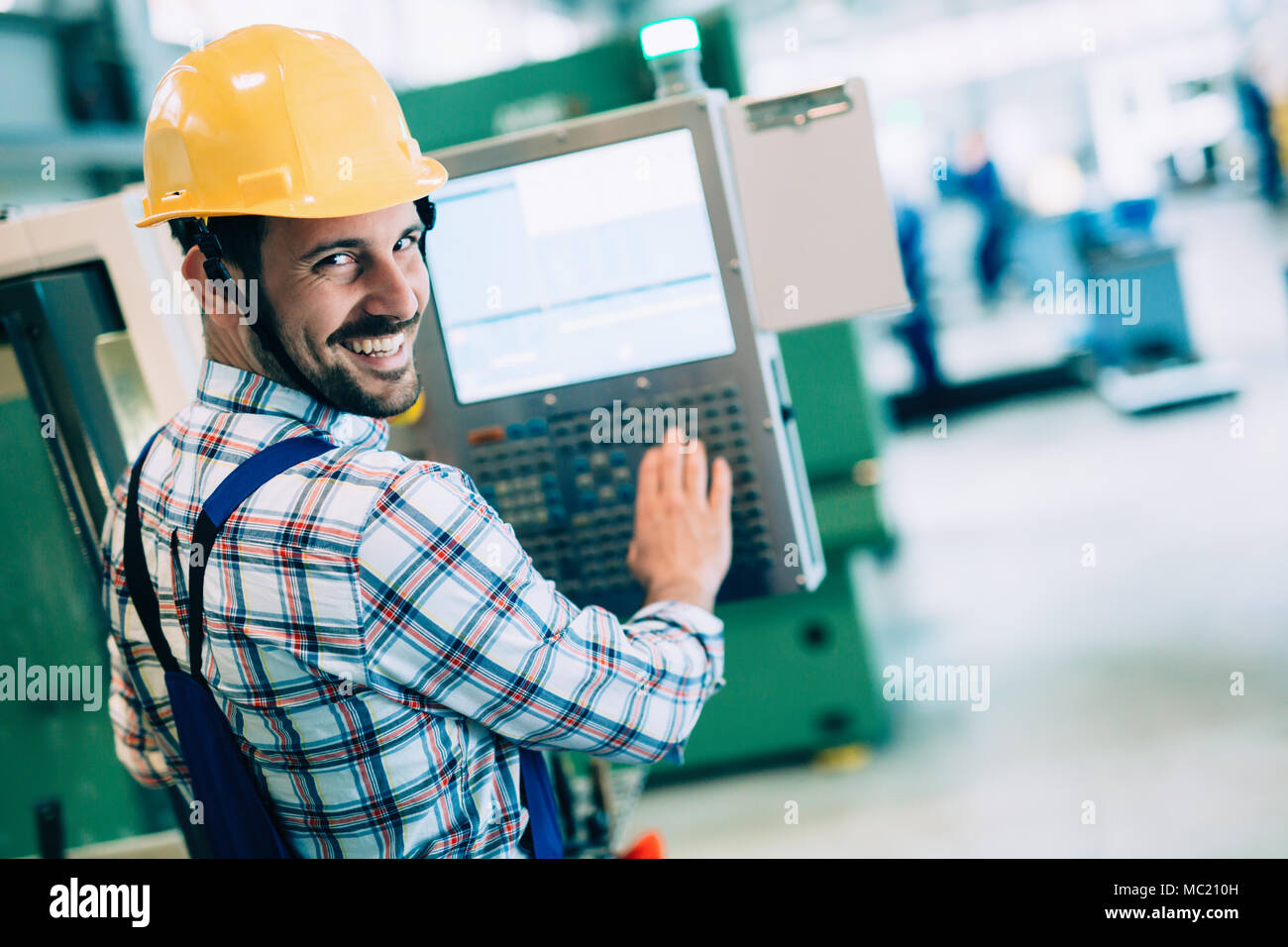 modern industrial machine operator working in factory Stock Photo - Alamy