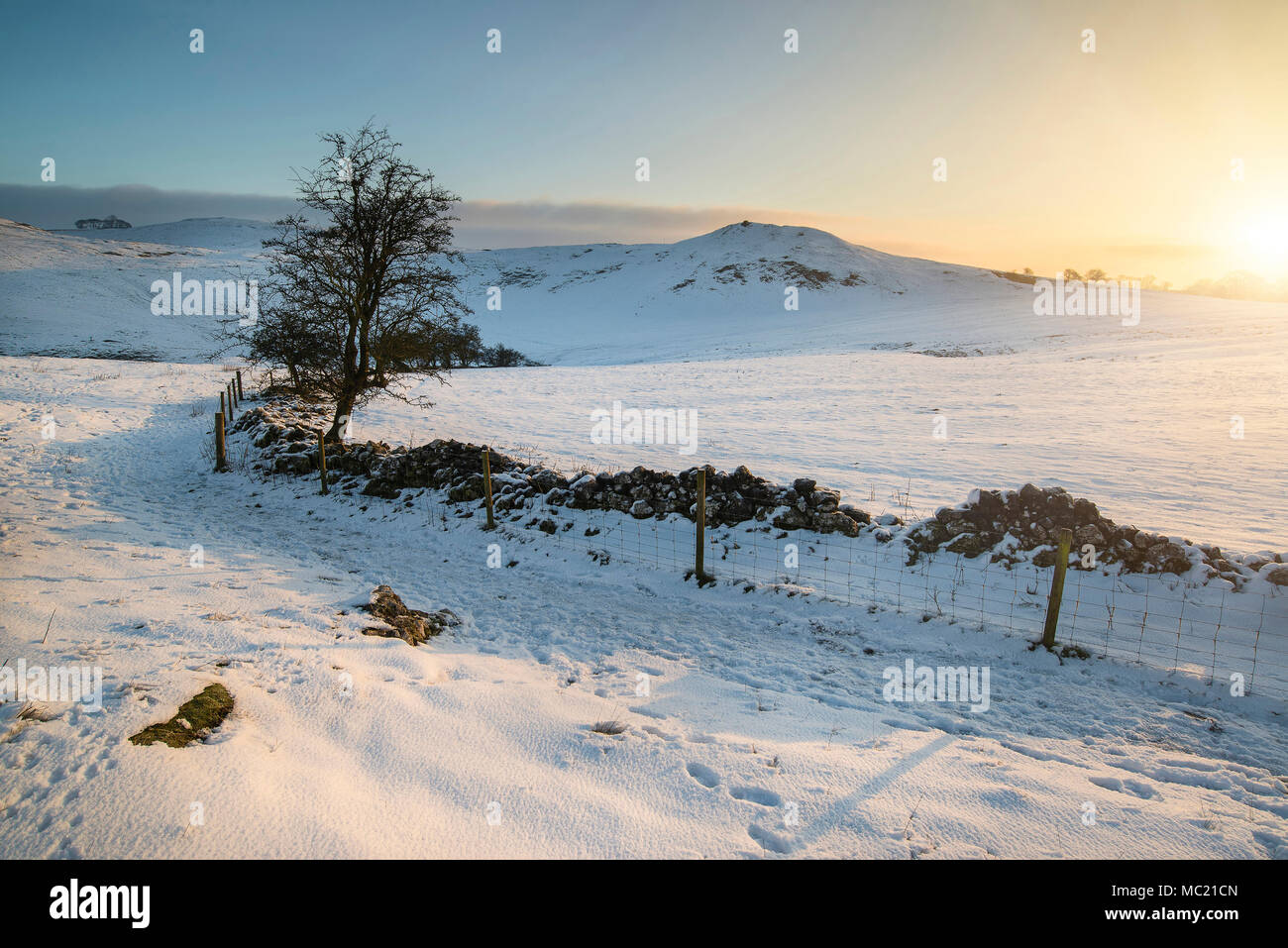 Snow covered Winter landscape at sunrise in Peak District in England ...