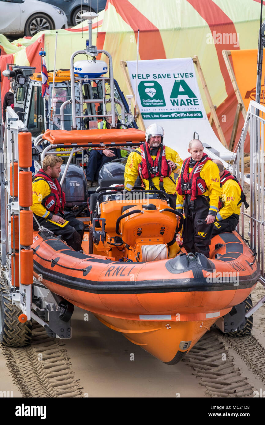 Volunteers of the Newquay RNLI crew preparing their rescue craft for ...
