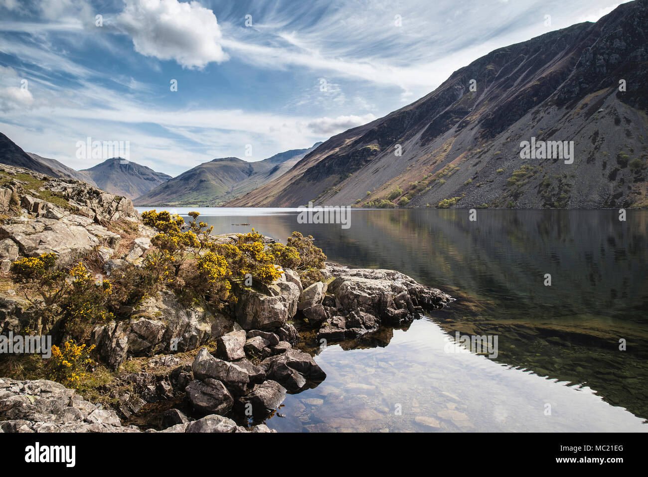 Lake District mountains landscape reflected in still lake of Wast Water ...