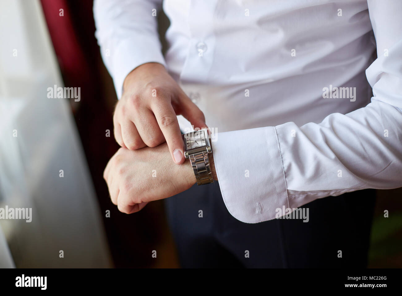 Man puts a watch hi-res stock photography and images - Alamy