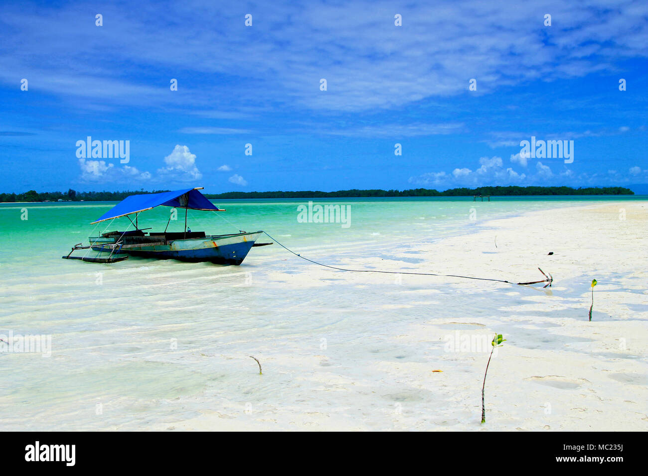 Boat on the beach in Widi archipelago, North Moluccas Stock Photo - Alamy