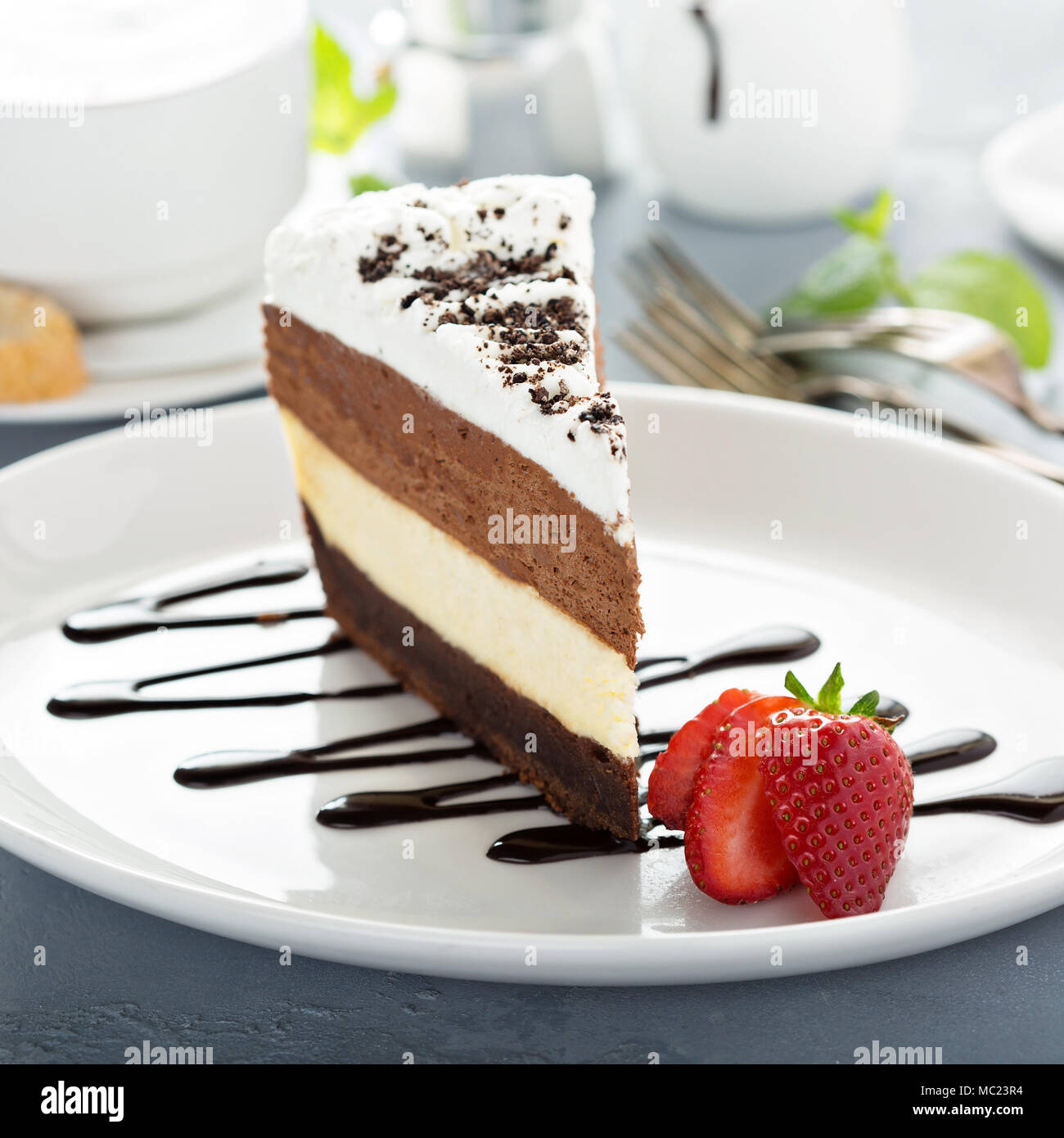 Three chocolate layered mousse cake Stock Photo - Alamy