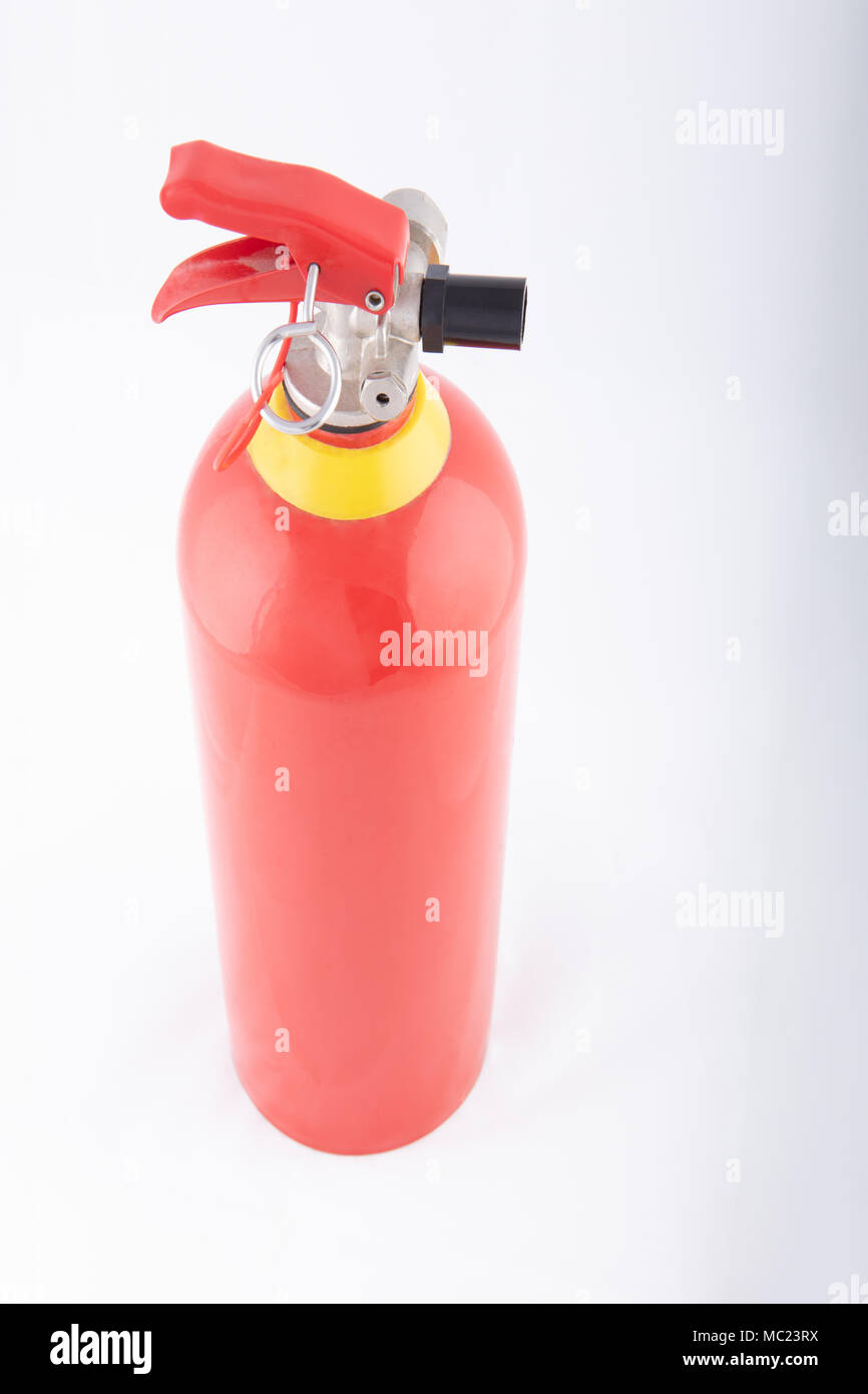 Top down view on a portable red fire extinguisher on a white floor with ...