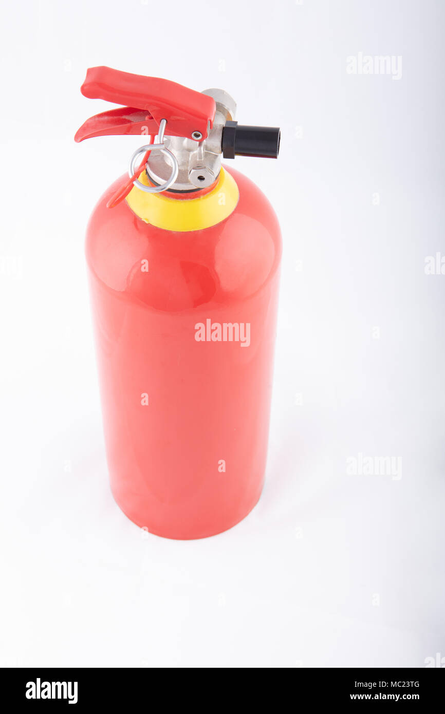 Top down view on a portable red fire extinguisher on a white floor with ...