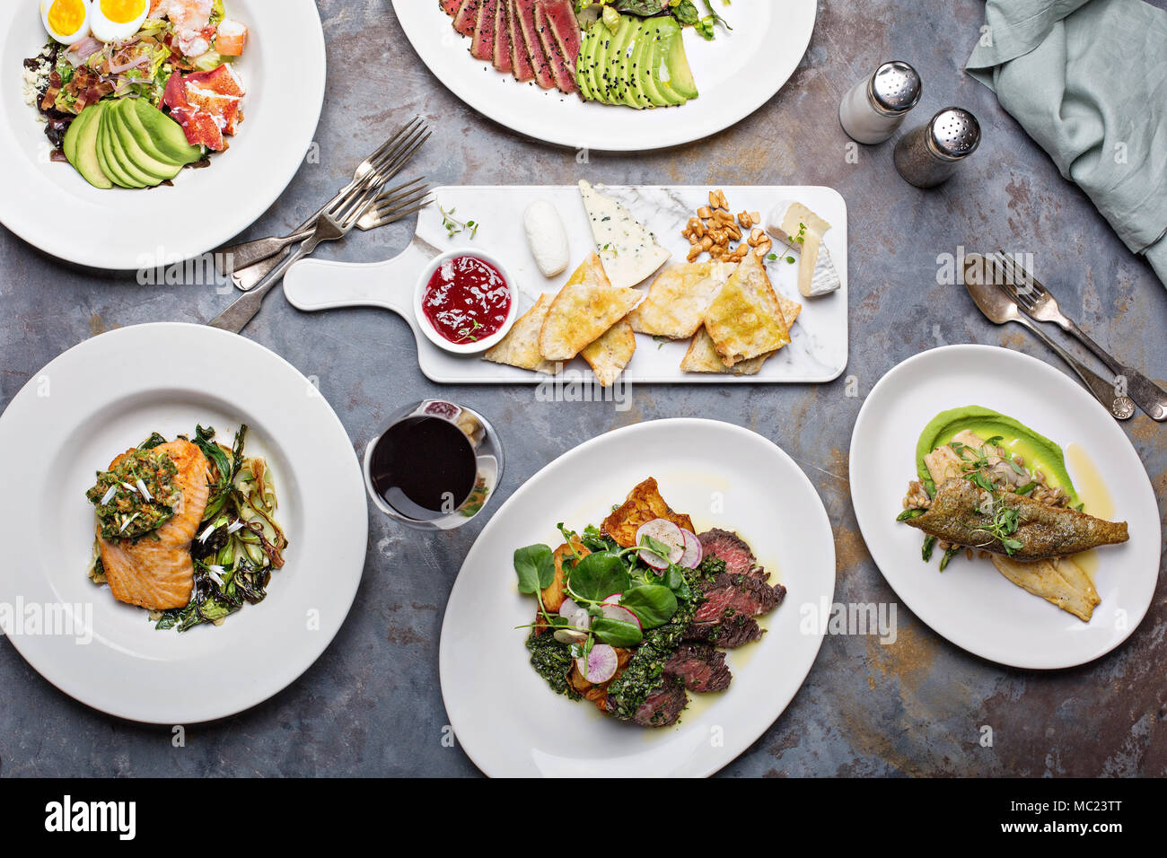 Big dinner table overhead view with steak and fish Stock Photo - Alamy
