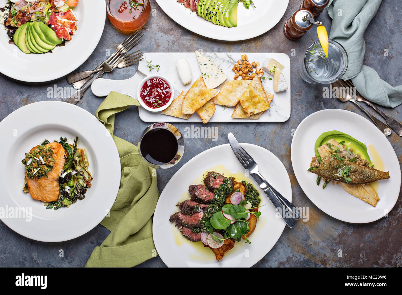 Big dinner table overhead view with steak and fish Stock Photo - Alamy