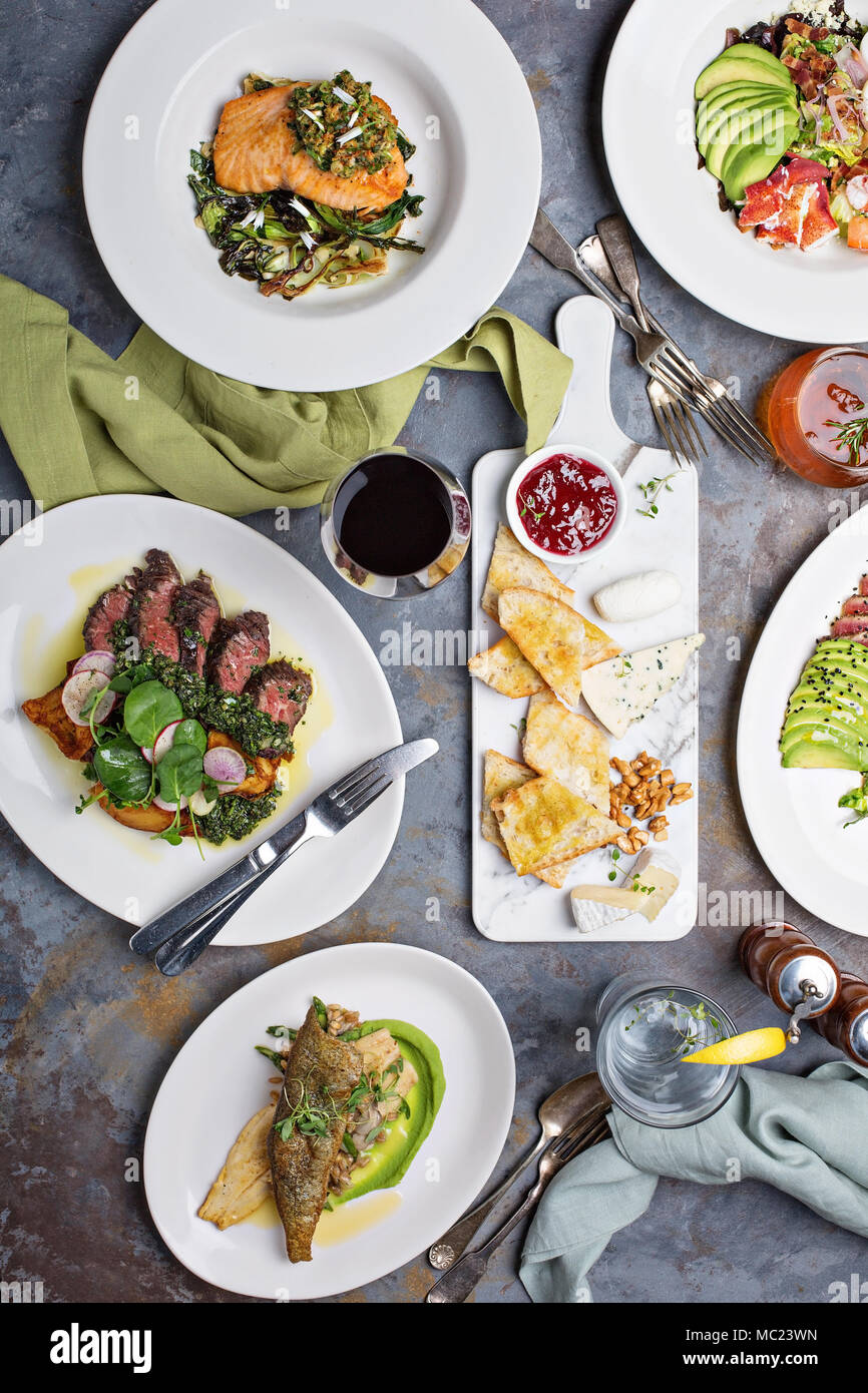 Big dinner table overhead view with steak and fish Stock Photo - Alamy