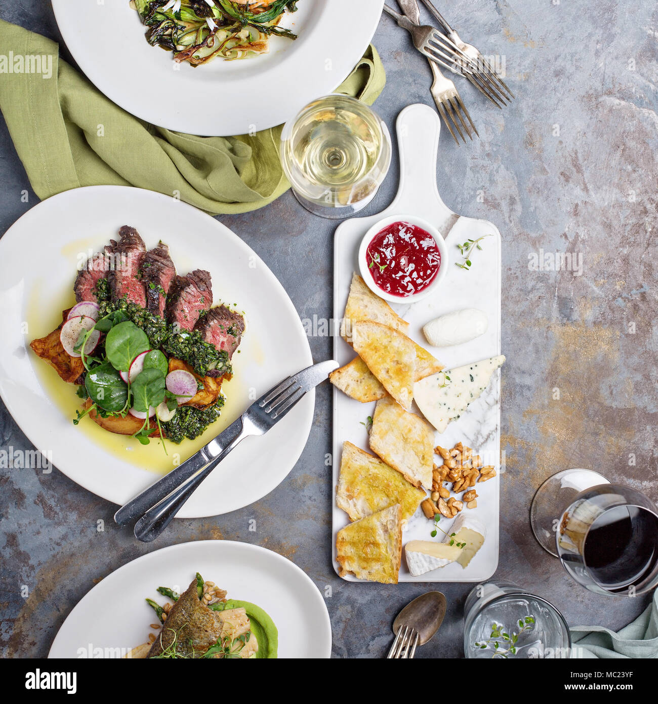 Big dinner table overhead view with steak and fish Stock Photo - Alamy