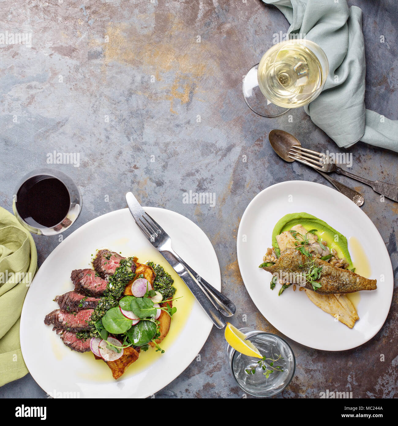 Big dinner table overhead view with steak and fish Stock Photo - Alamy
