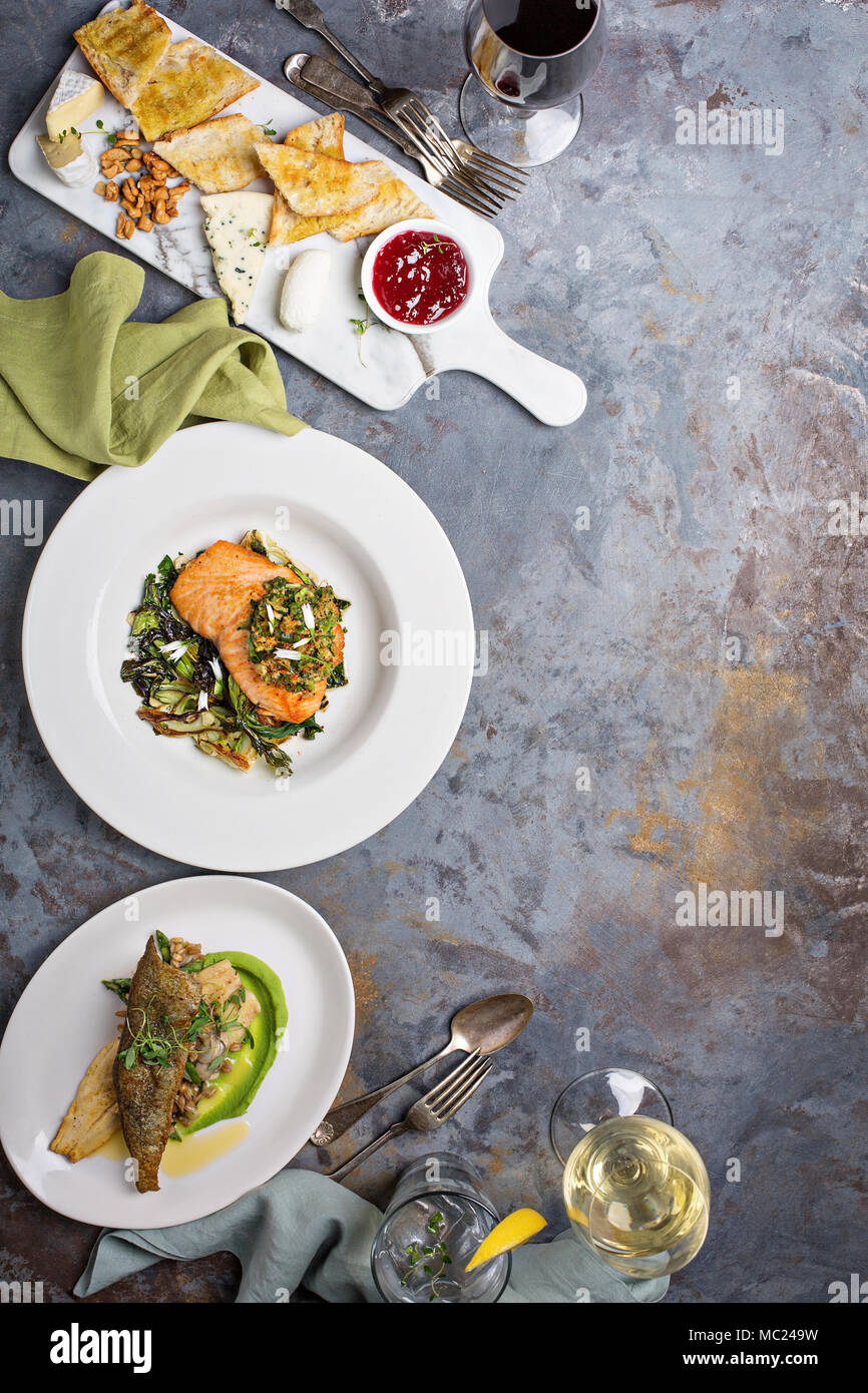 Big dinner table overhead view with steak and fish Stock Photo - Alamy