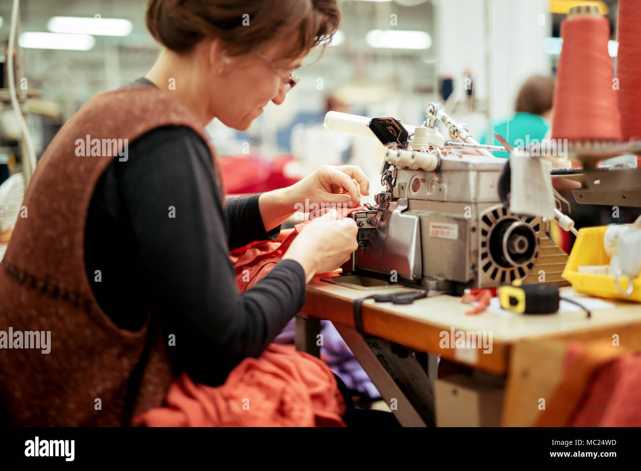 Woman working in textile industry Stock Photo - Alamy