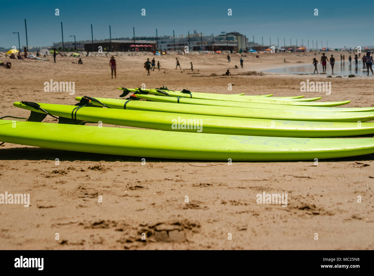 surf boards on a beach. lined up in the sand Stock Photo - Alamy