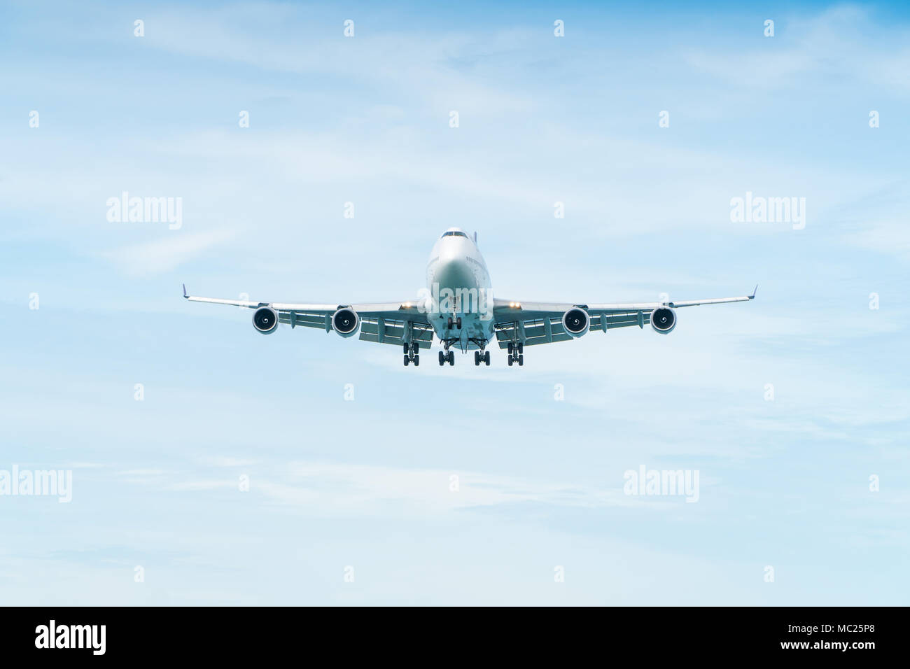 Airplane aircraft flying, landing in the good weather at blue cloudy ...