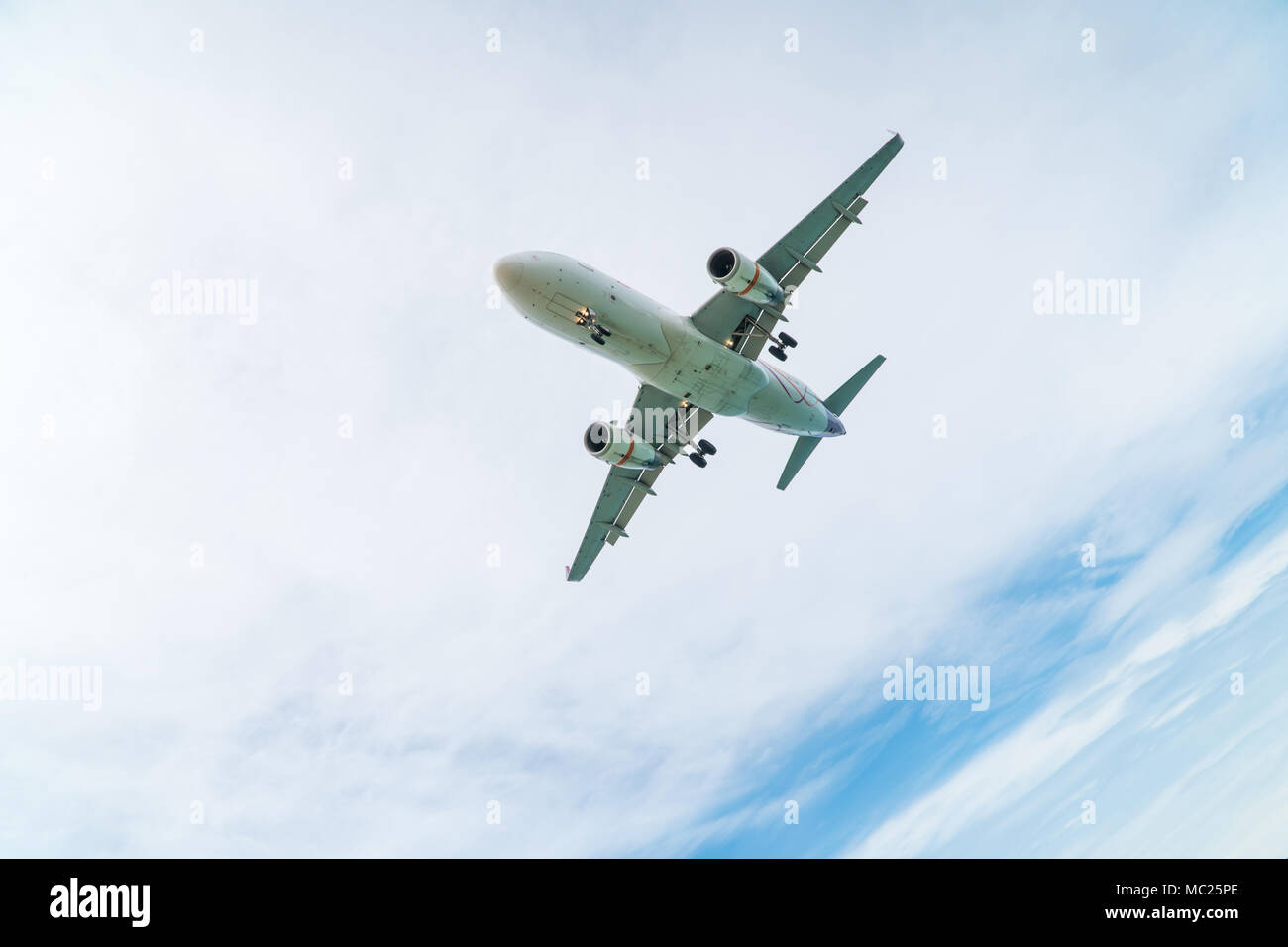 Airplane aircraft flying, landing in the good weather at blue cloudy ...