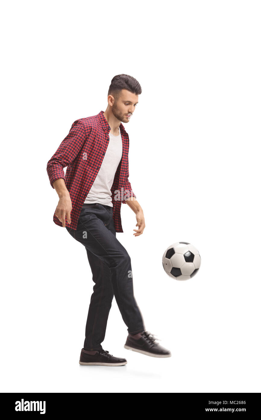 Full length profile shot of a young guy juggling a football isolated on ...