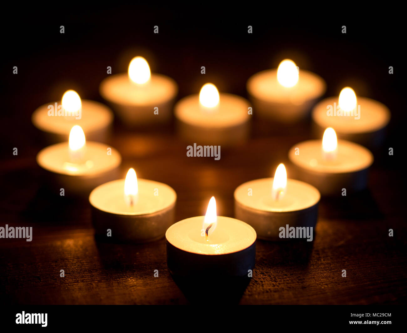 hearth-shape from candle light on dark background with bokhe. Shallow ...