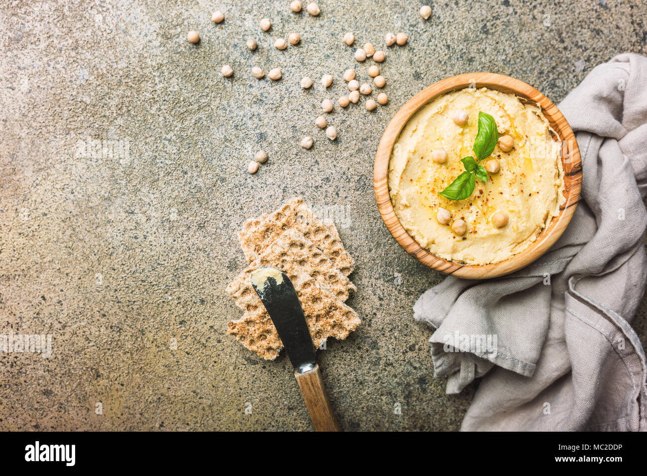 Healthy Homemade Creamy Hummus with Olive Oil over stone background ...