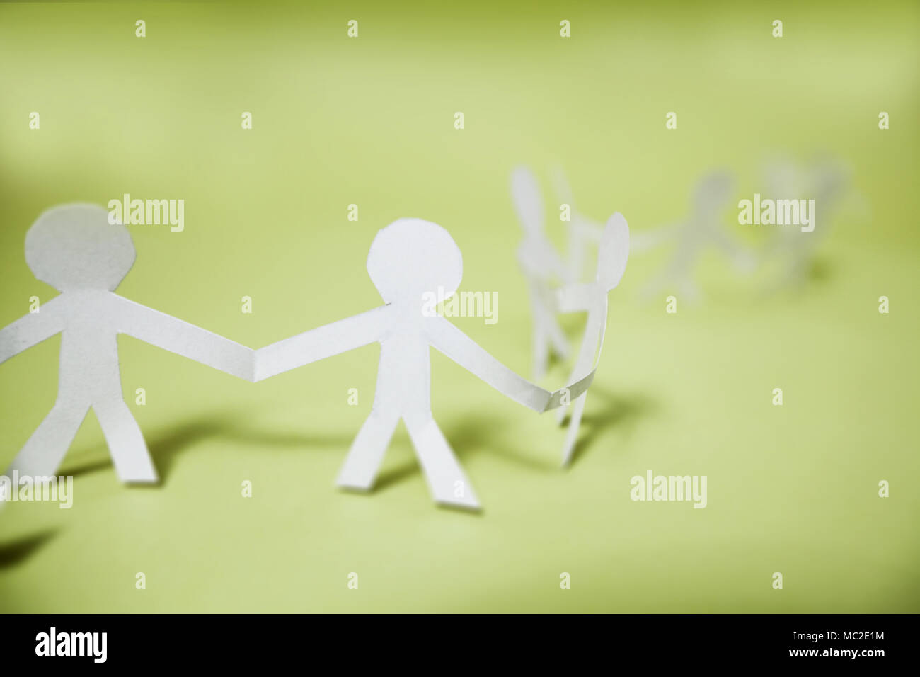 Connected support together, team paper doll people chain Stock Photo ...