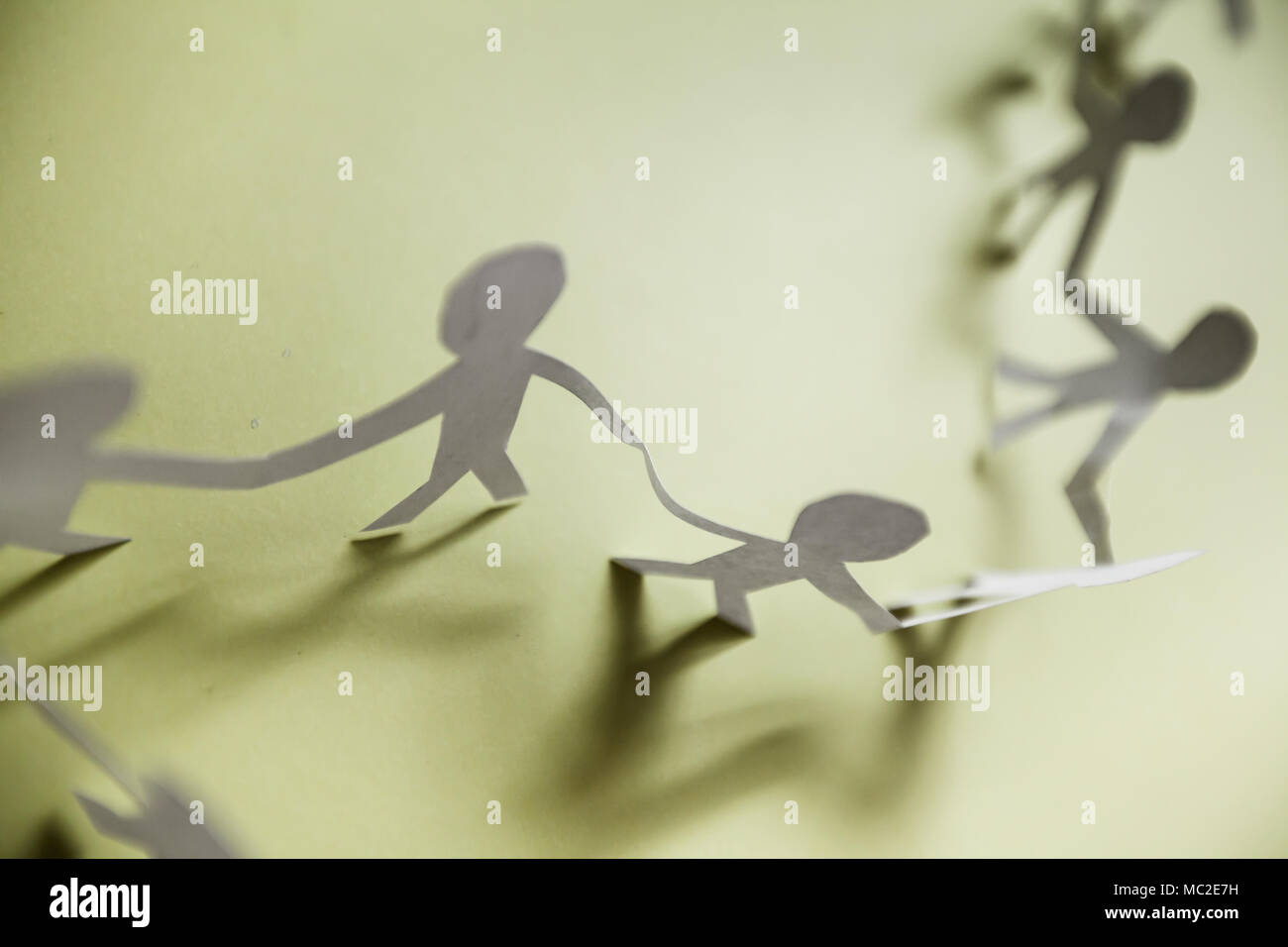 Connected support together, team paper doll people chain Stock Photo ...