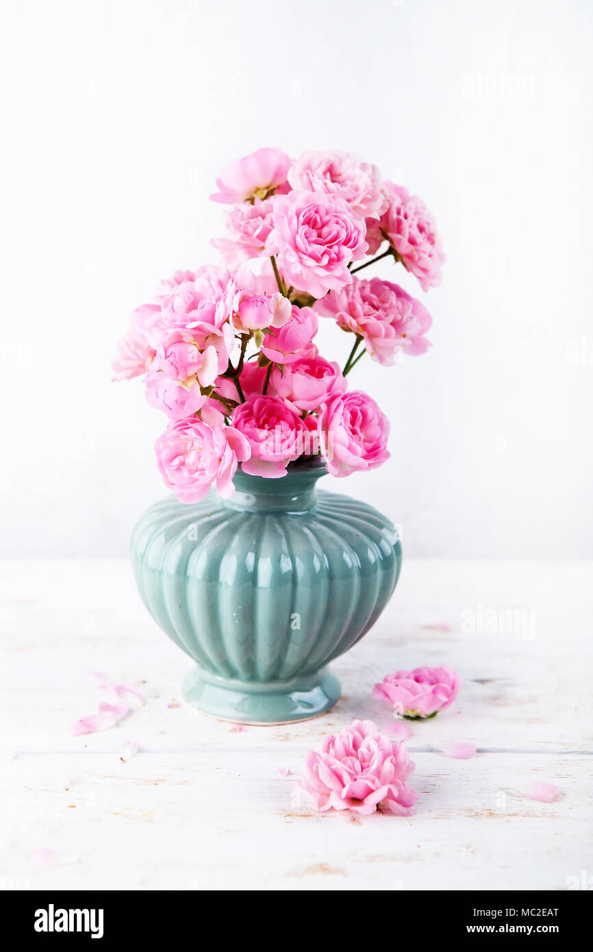 Rose placed on the desk in white background Stock Photo - Alamy
