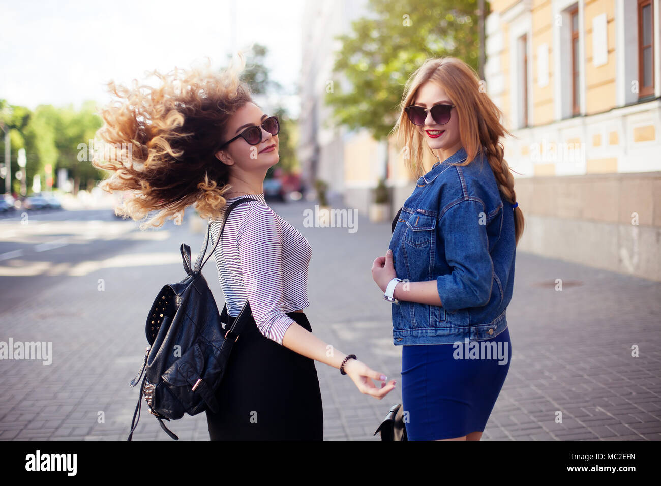 Outdoor lifestyle portrait of two best friends, smiling and having fun ...