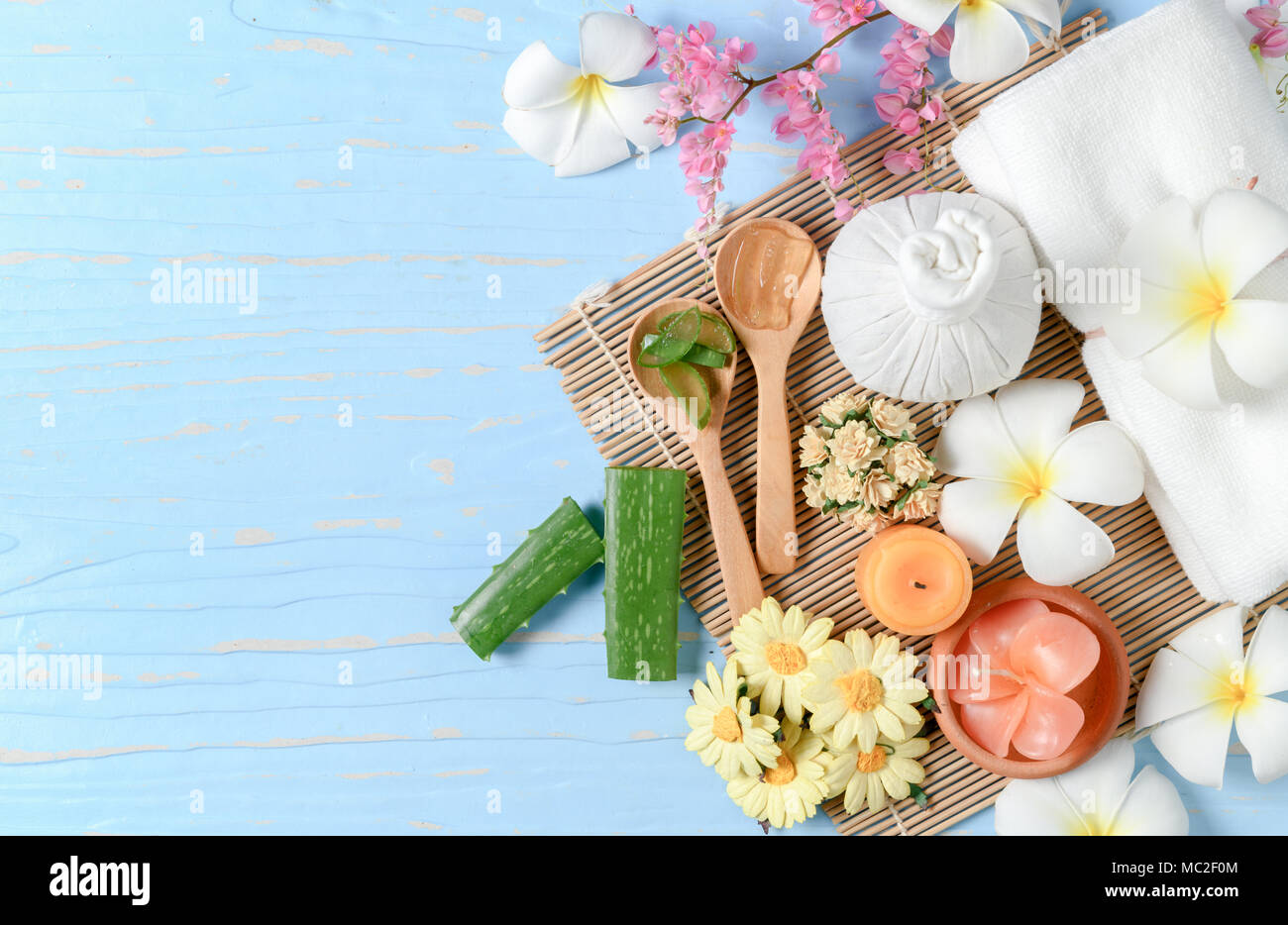 Aloe vera and Herbal Compress on blue wood background, ingredient spa ...