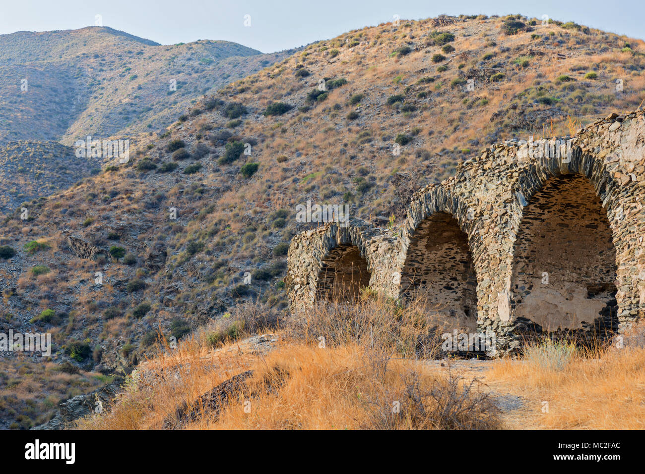 An ancient wall with an arch of stone built in the mountains. Almeria ...
