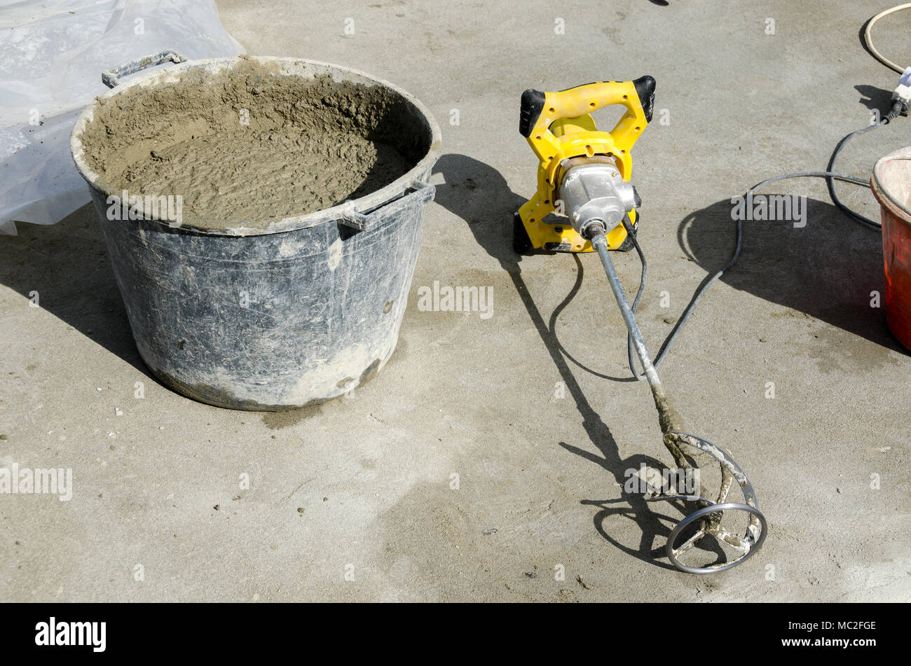 worker who throws cement on a building site for the renovation of a ...