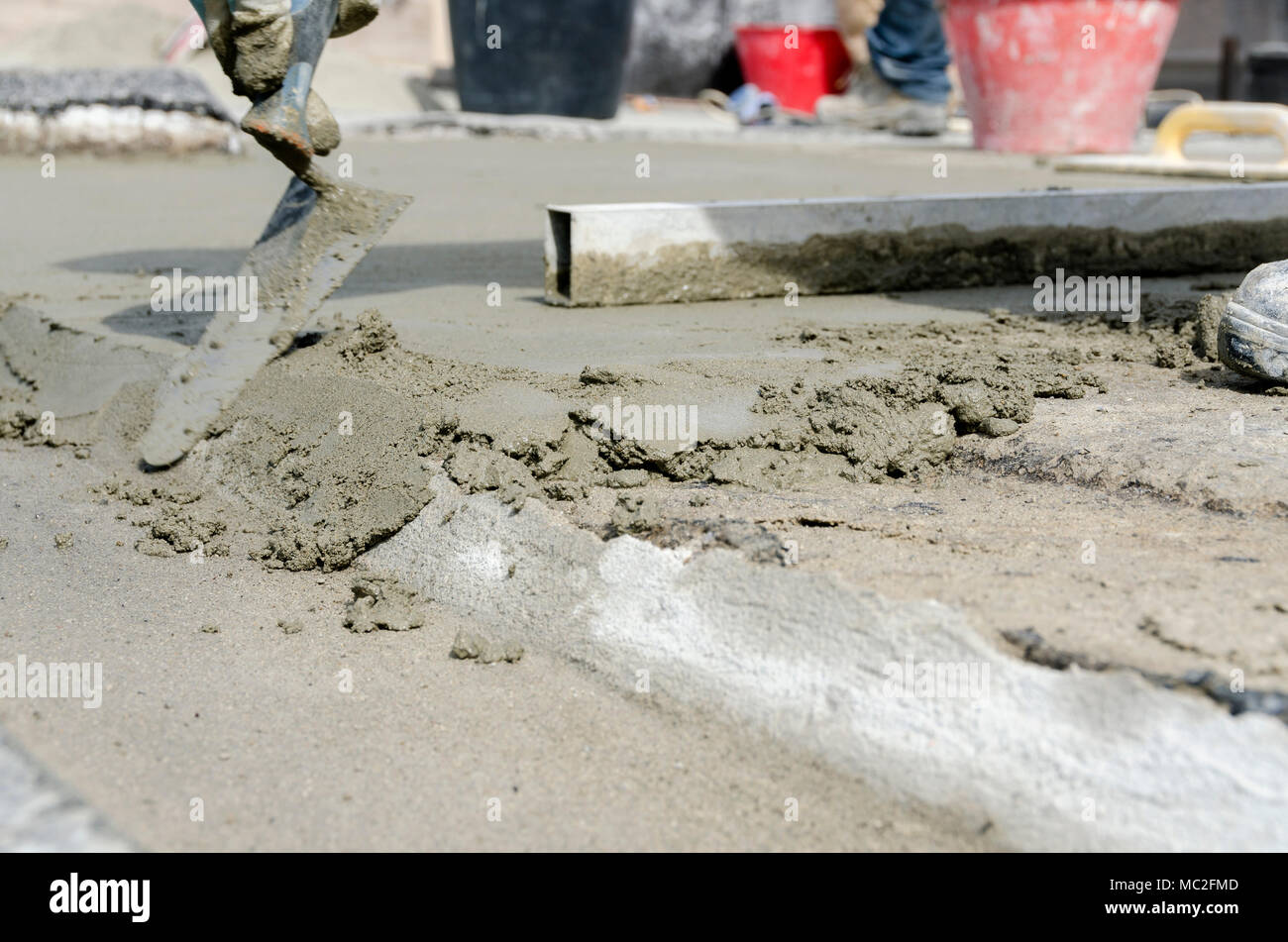 worker who throws cement on a building site for the renovation of a ...