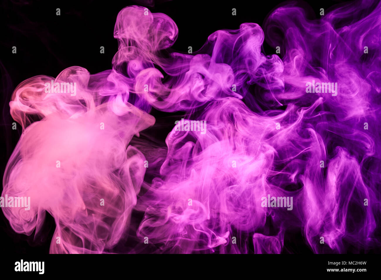 Thick pink colorful smoke on a black isolated background. Background ...