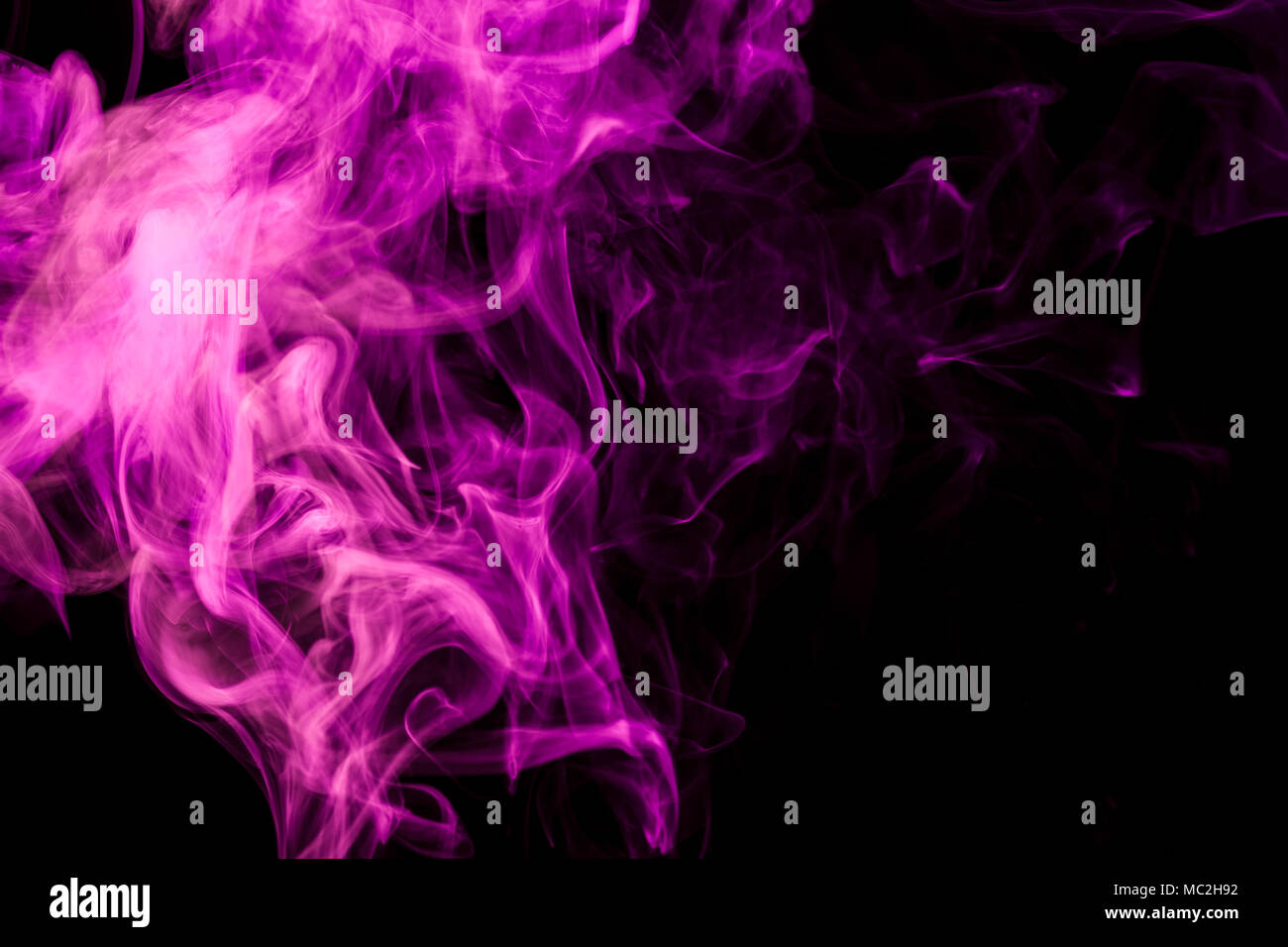 Thick pink colorful smoke on a black isolated background. Background ...