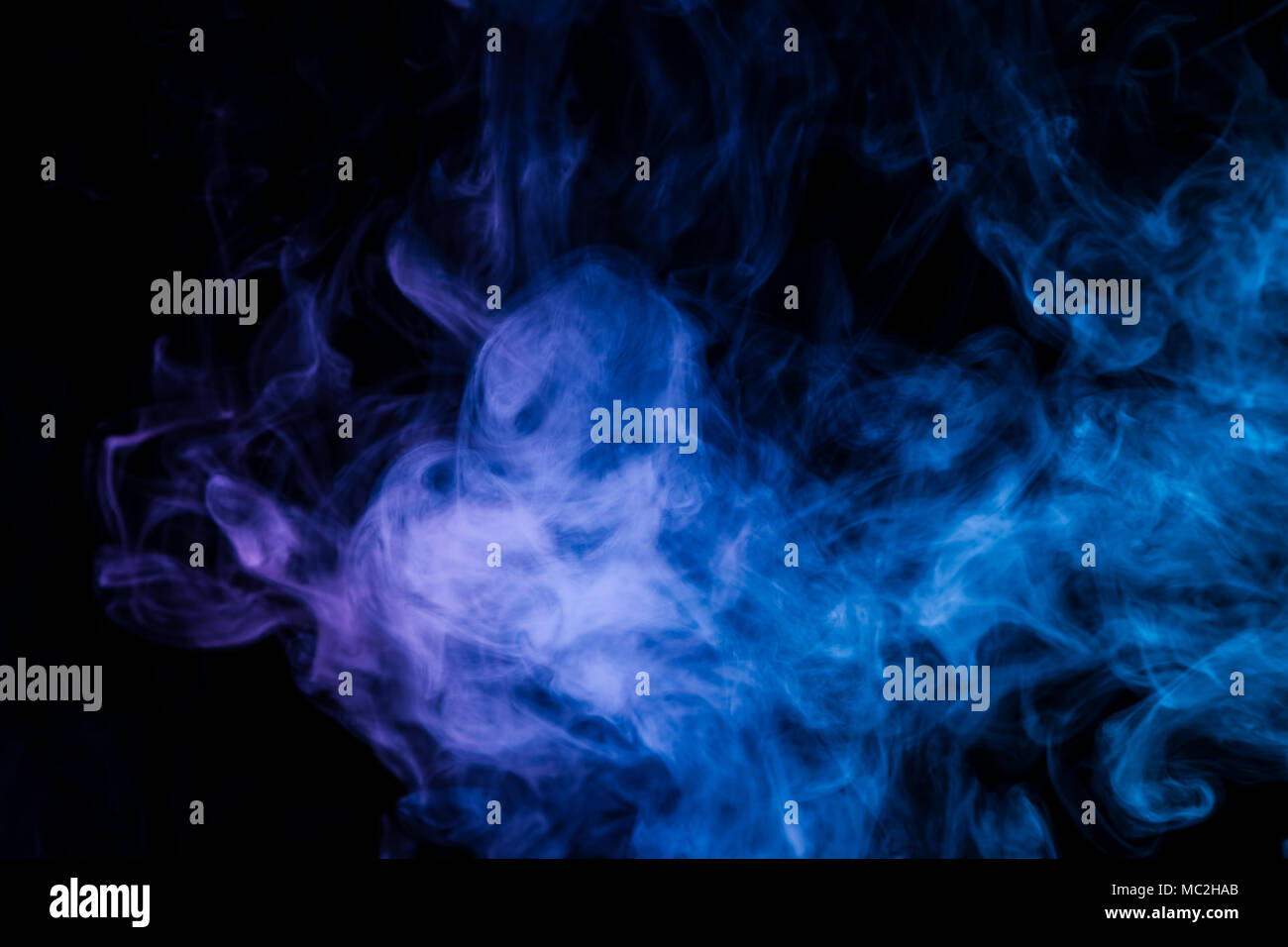 Colorful blue smoke on a black isolated background. Background from the ...