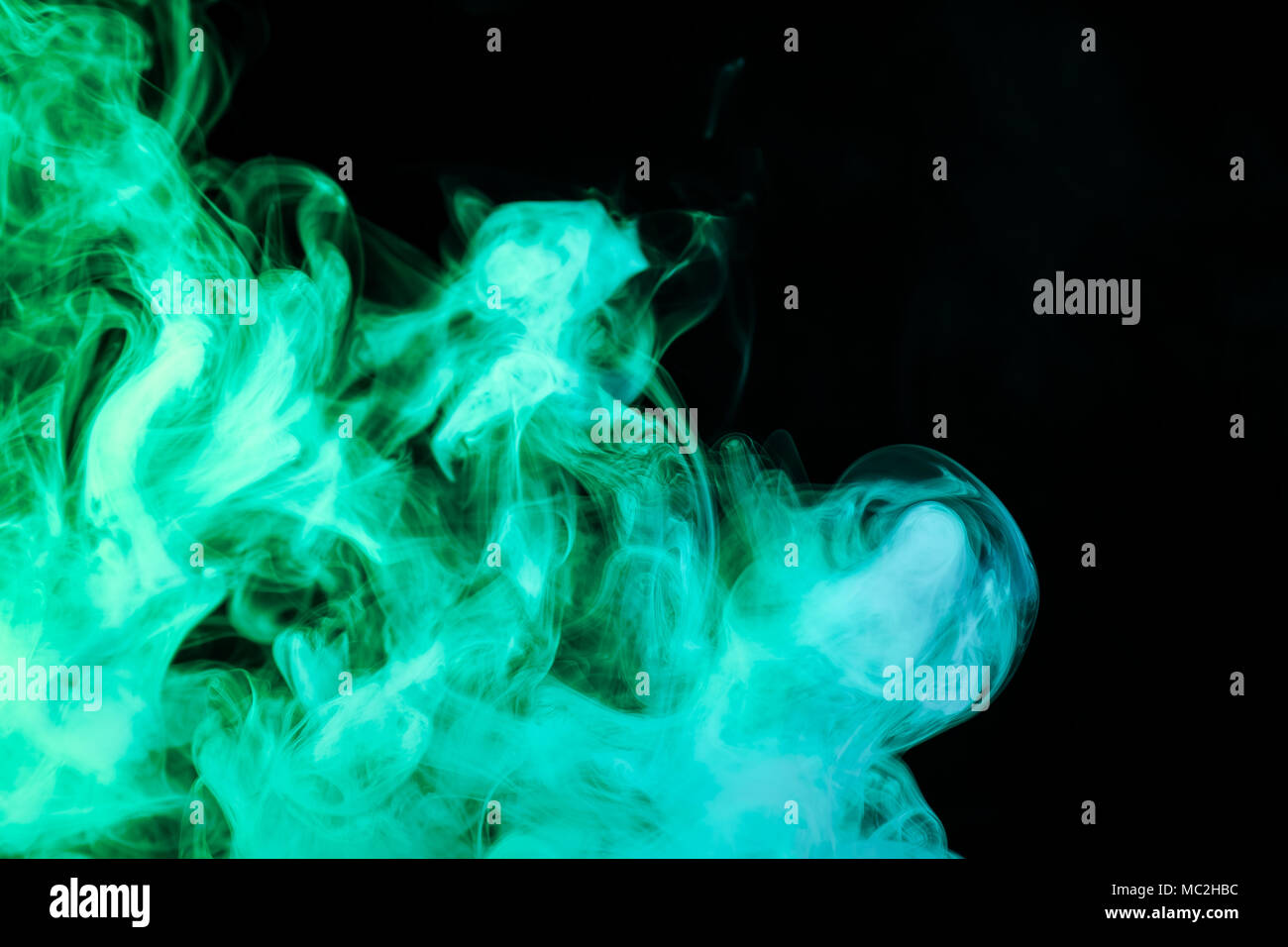 Colorful green smoke on a black isolated background. Background from ...