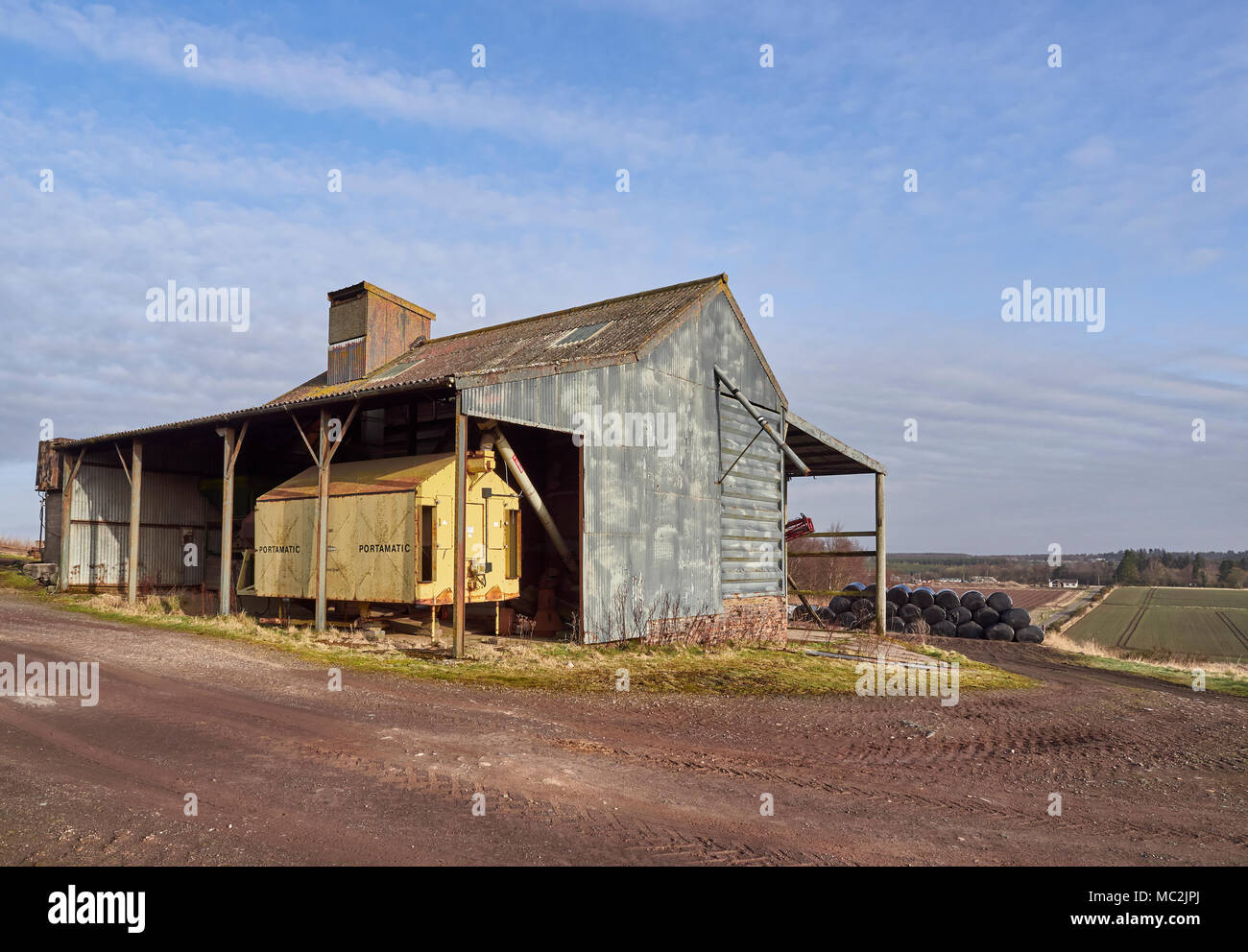 An abandoned Portamatic Grain Dryer stored under a Lean To within an ...