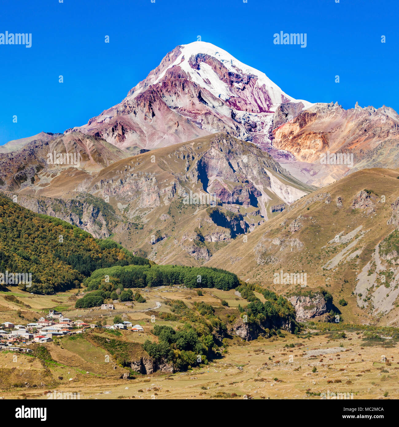 Aerial view of Mount Kazbek and Stepantsminda town in Georgia. It is a ...