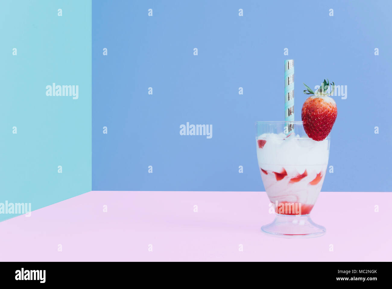 Milkshake with straw and strawberry Stock Photo - Alamy