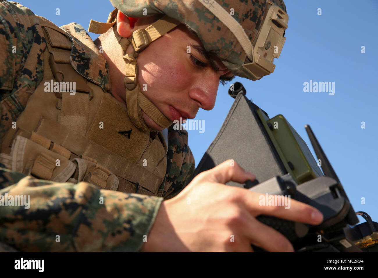 A Marine views real-time feedback from a camera attached to an unmanned ...