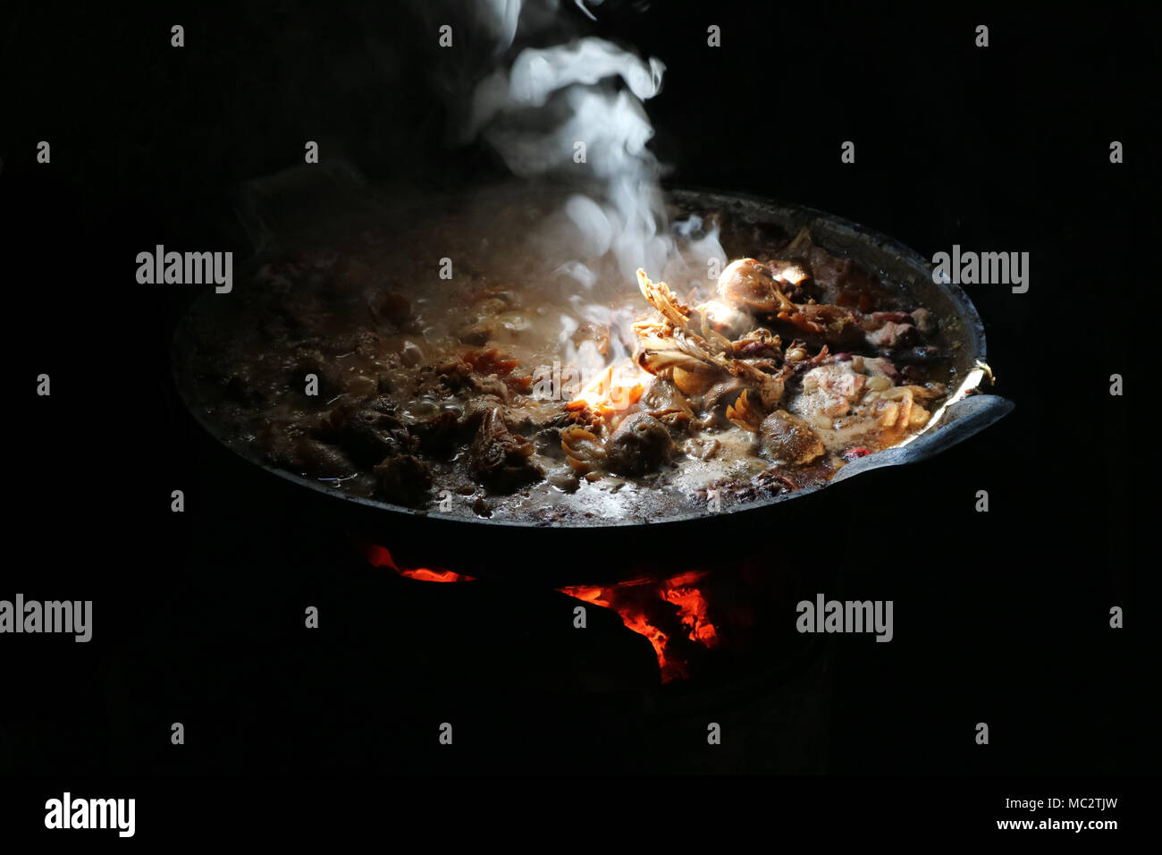 entrails chicken soup boil on large frying pan and smoke of food smell ...