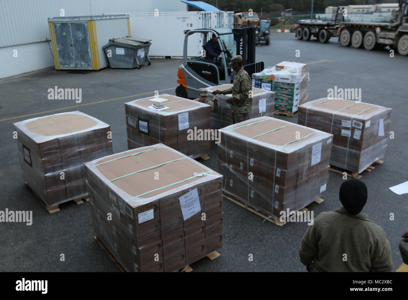 U.S. Soldiers mark food pallets for transport to their respective units ...